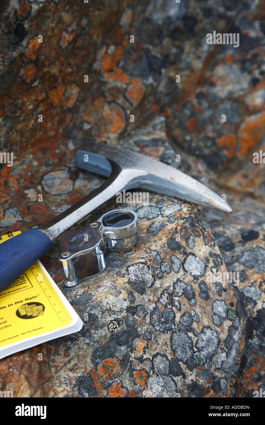 Mining concept image of geologists rock hammer notebook and magnifier ...