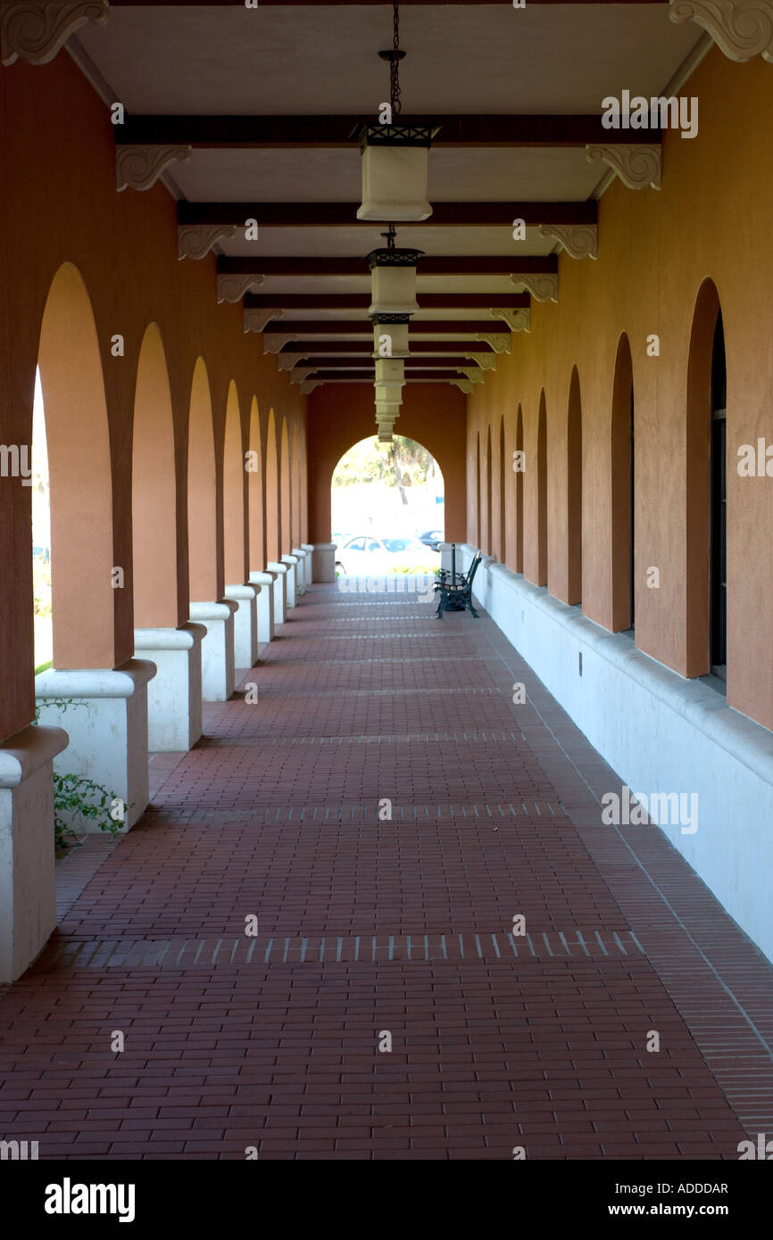 Long Outdoor Hallway With Arched Entrance Ways And Hanging Lights Stock long-outdoor-hallway-with-arched-entrance-ways-and-hanging-lights-stock
