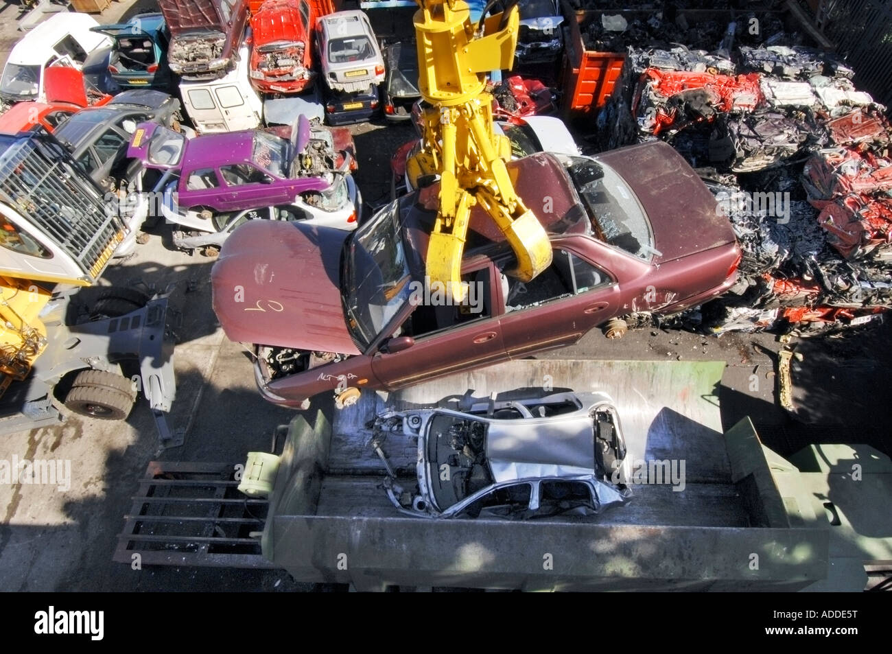 Cubes of crushed cars stand in a huge pile at a car recycling and ...