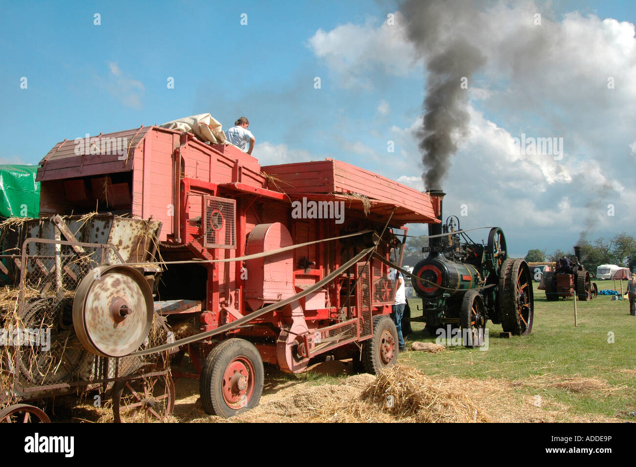 Marshall threshing drum driven by agricultural traction engine at work ...