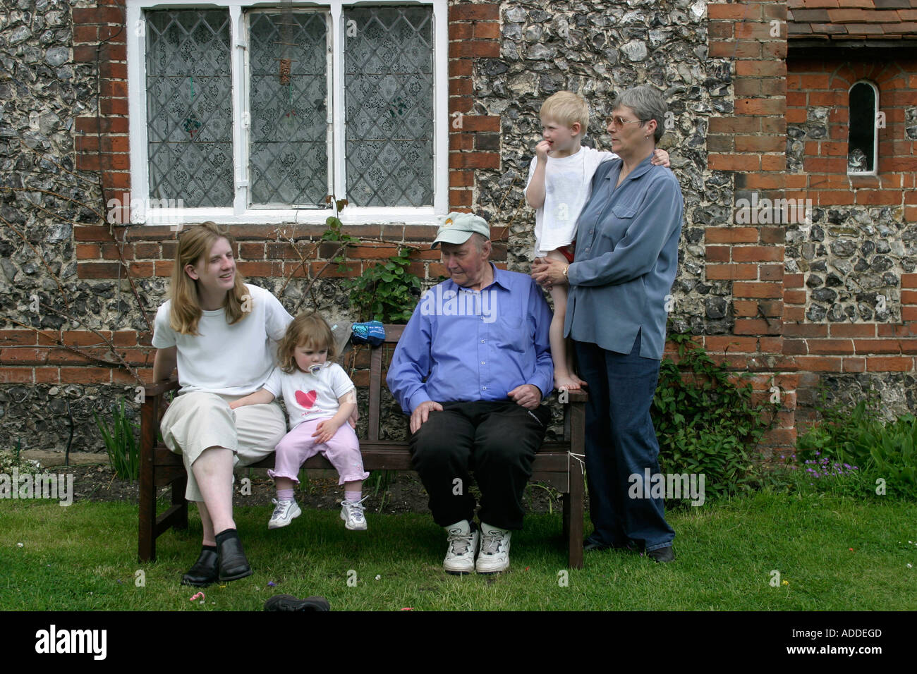 Three generations enjoy the sunshine. Daughter with her children visits ...