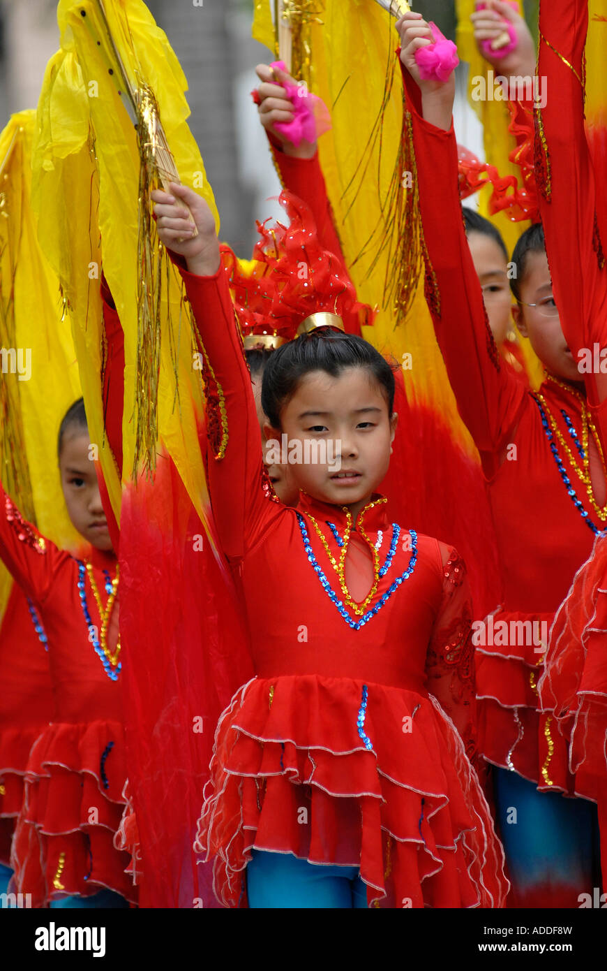 Young Chinese girls in festive outfits taking part in a parade during ...