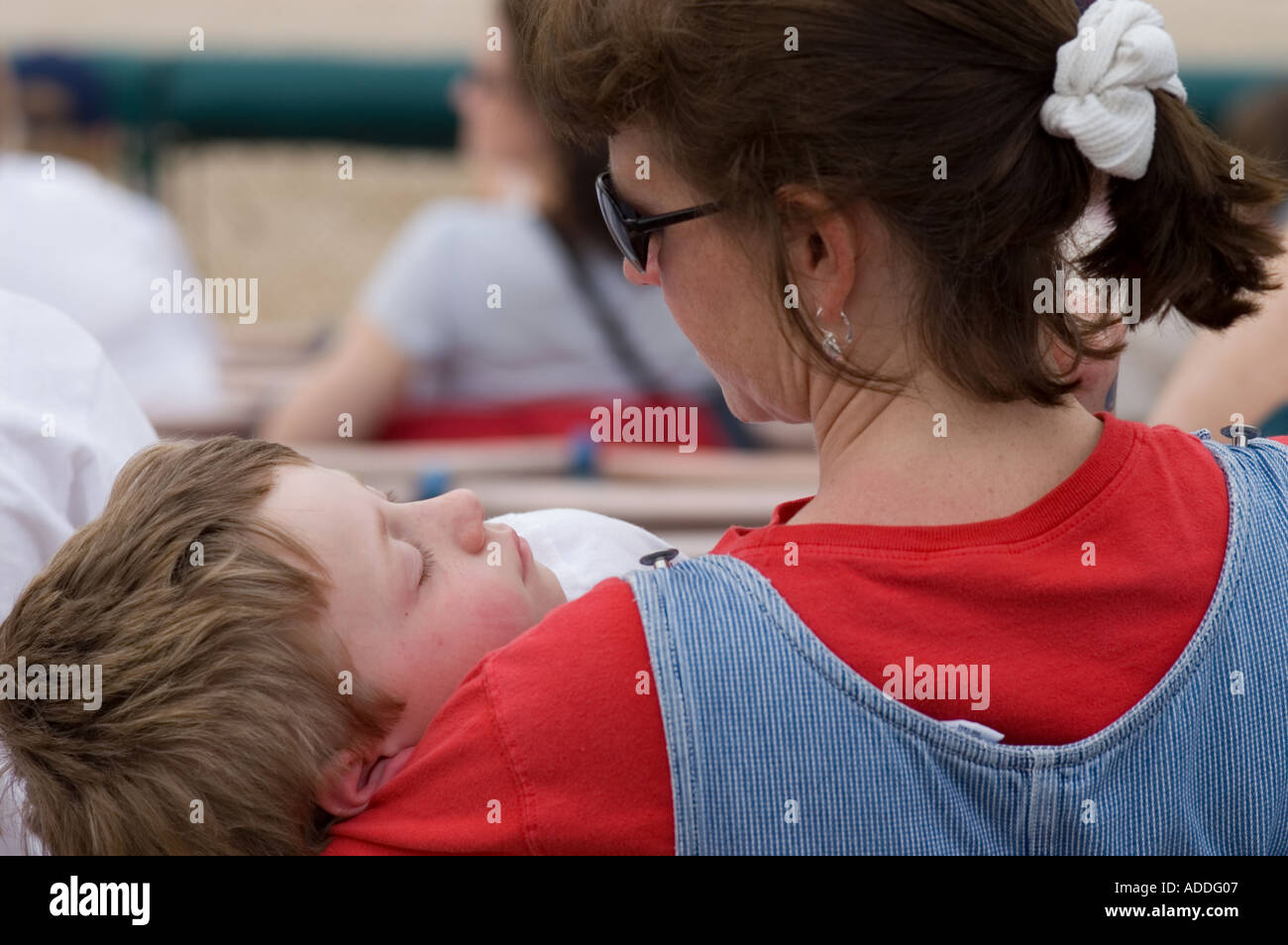 "His First Baseball Game" (sleeping child with mother Stock Photo - Alamy