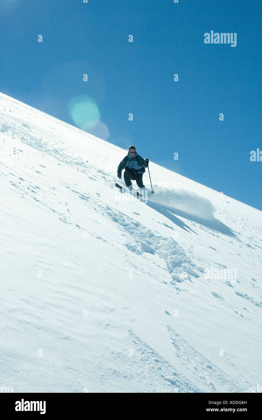 Skier descending steep slope hi-res stock photography and images - Alamy