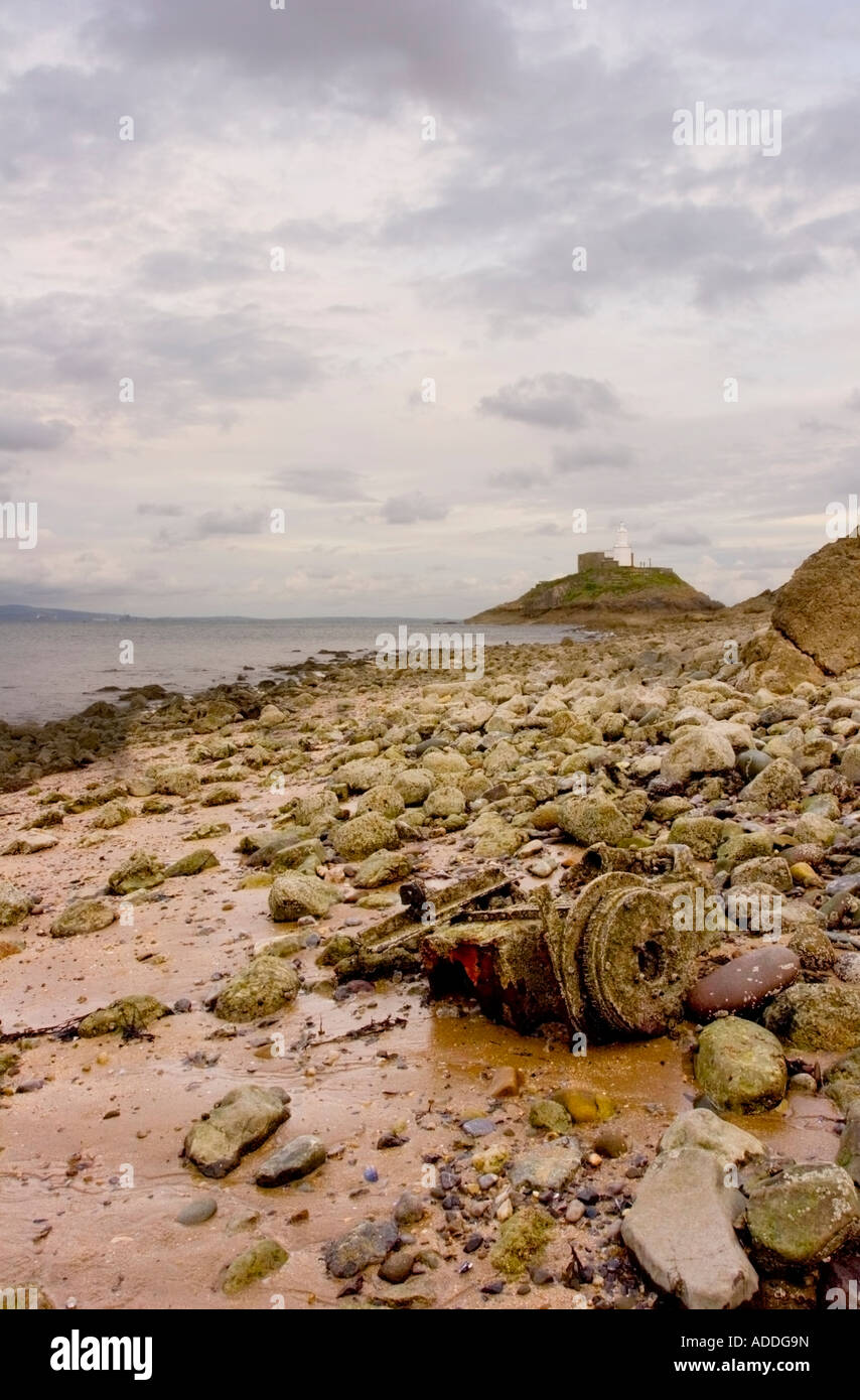 The Mumbles lighthouse as seen from the beach under pier.The tide is ...