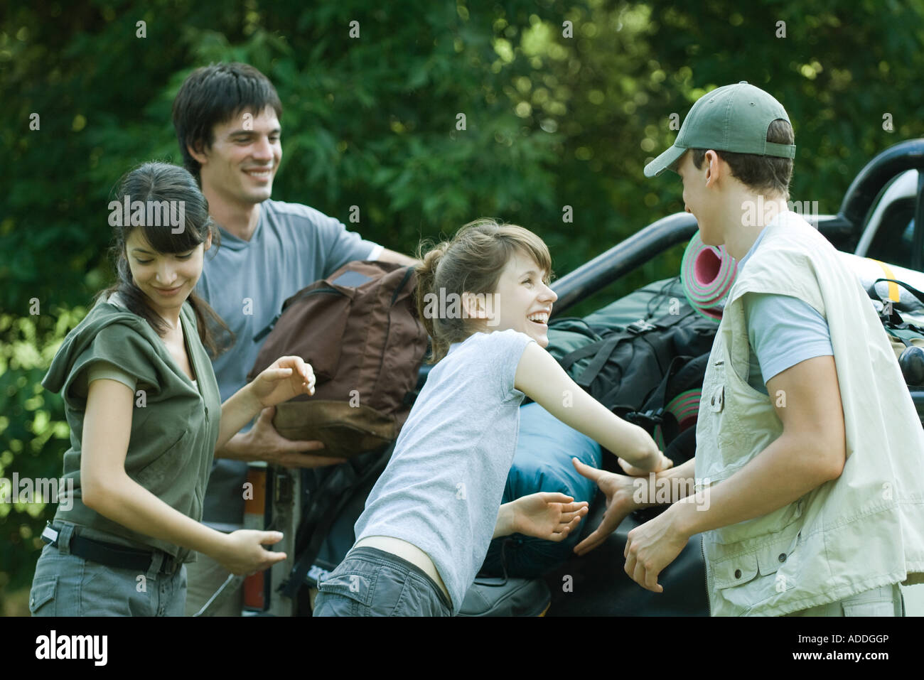 Group of hikers loading back of pick-up truck Stock Photo - Alamy