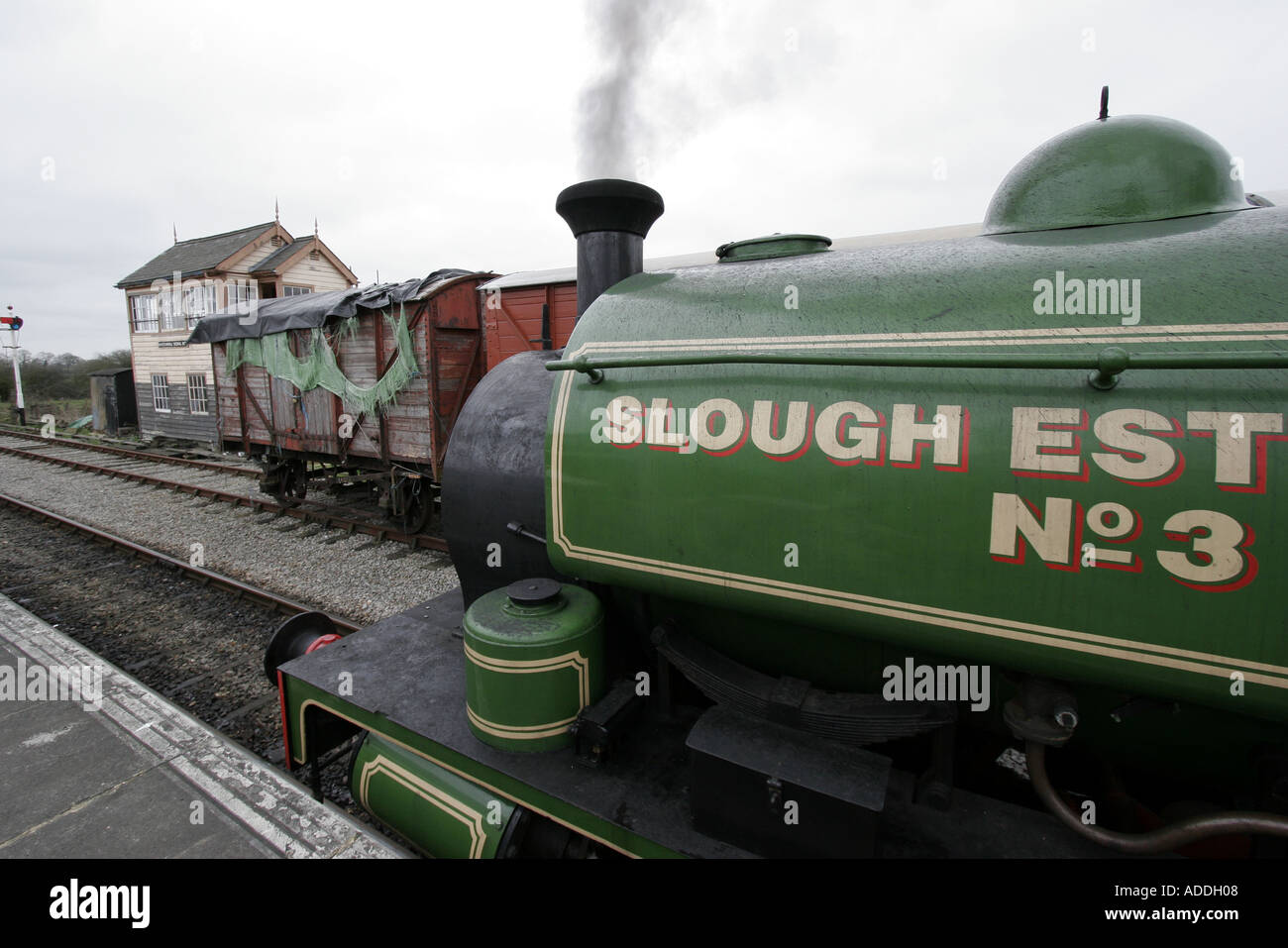 Train pulls into platform of preserved railway station Stock Photo - Alamy