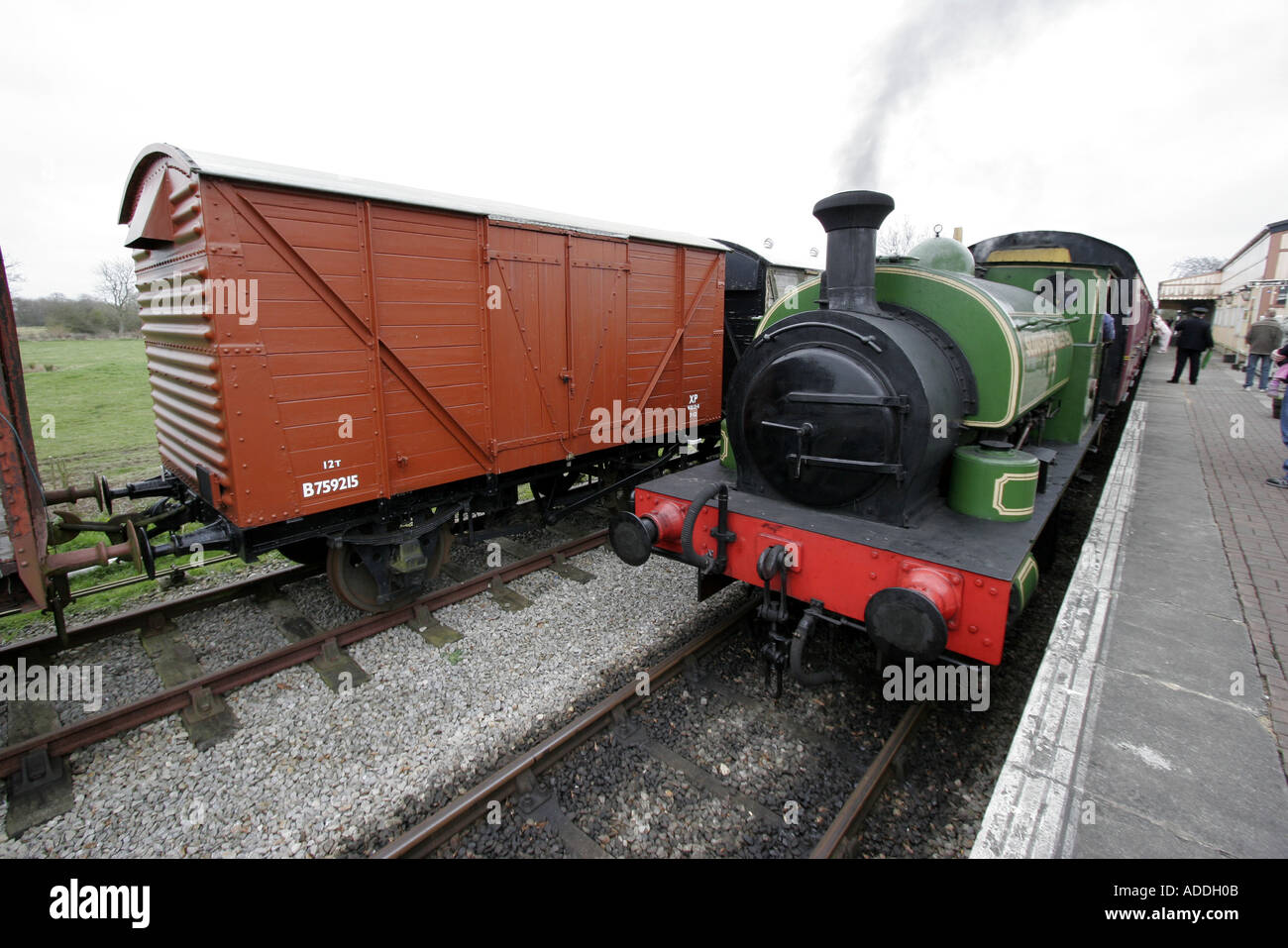 Train pulls into platform of preserved railway station Stock Photo - Alamy