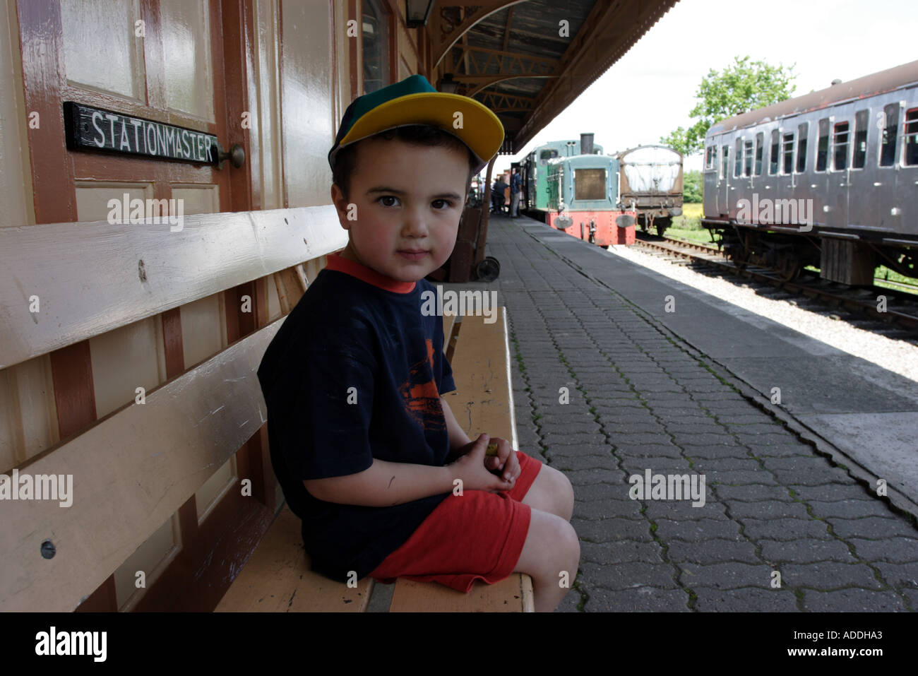 Small boy holding his tickets and waiting for the train to arrive Stock ...