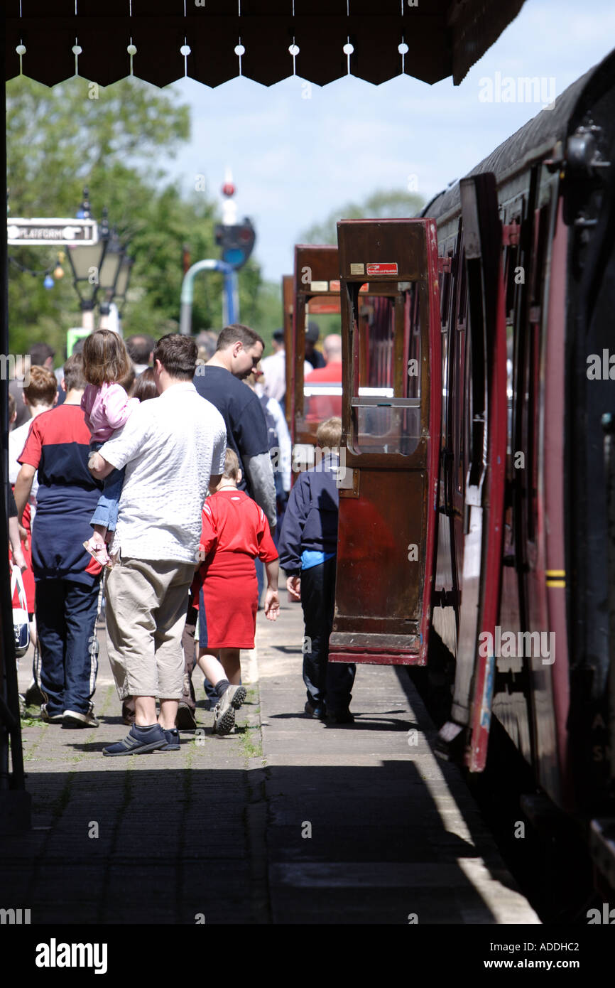 Crowded platform with passengers getting on and off a steam train Stock ...