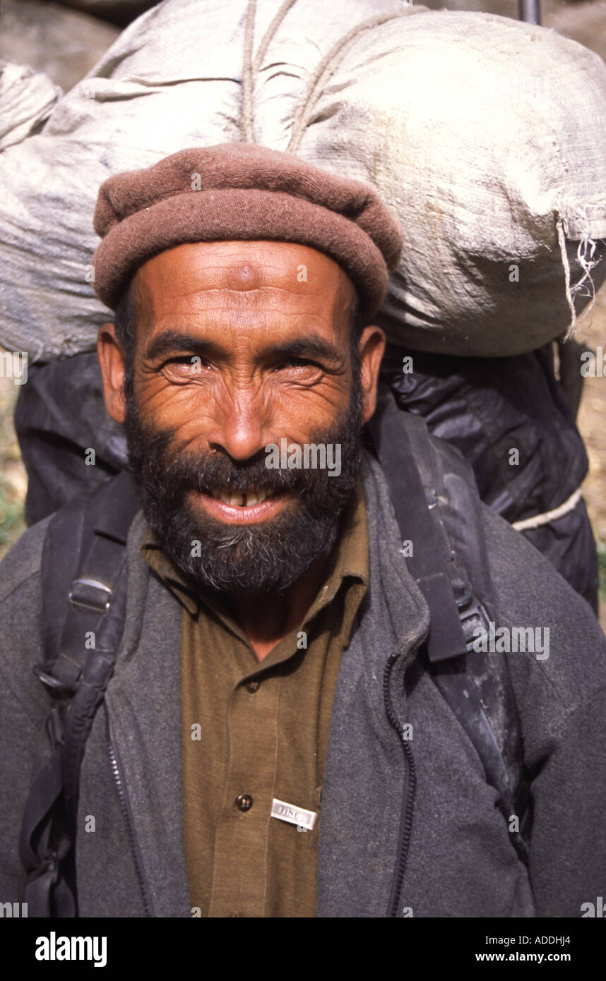 A mountain porter carries heavy loads up the Baltoro Glacier in the ...