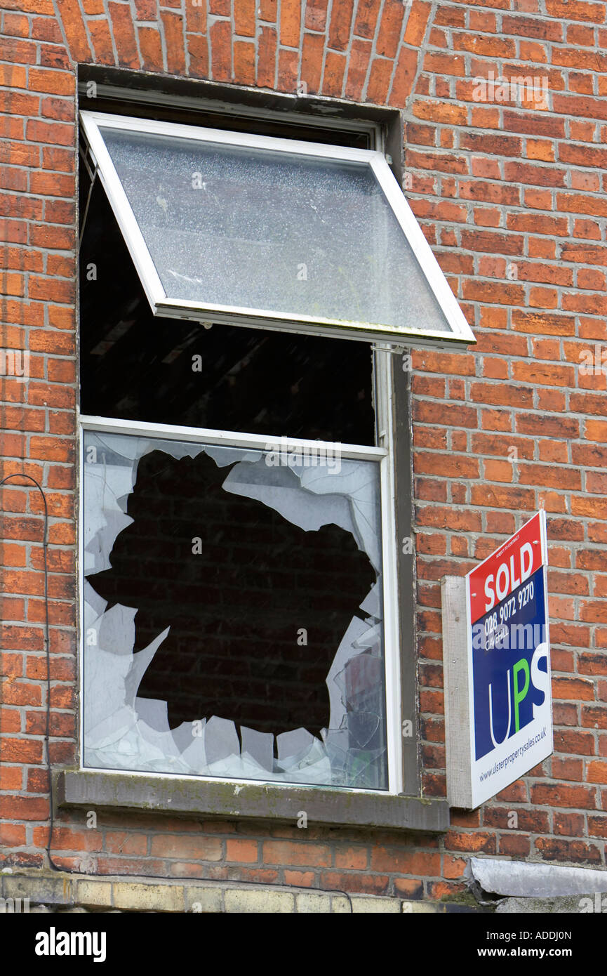 smashed double glazed window of sold house for development Stock Photo ...