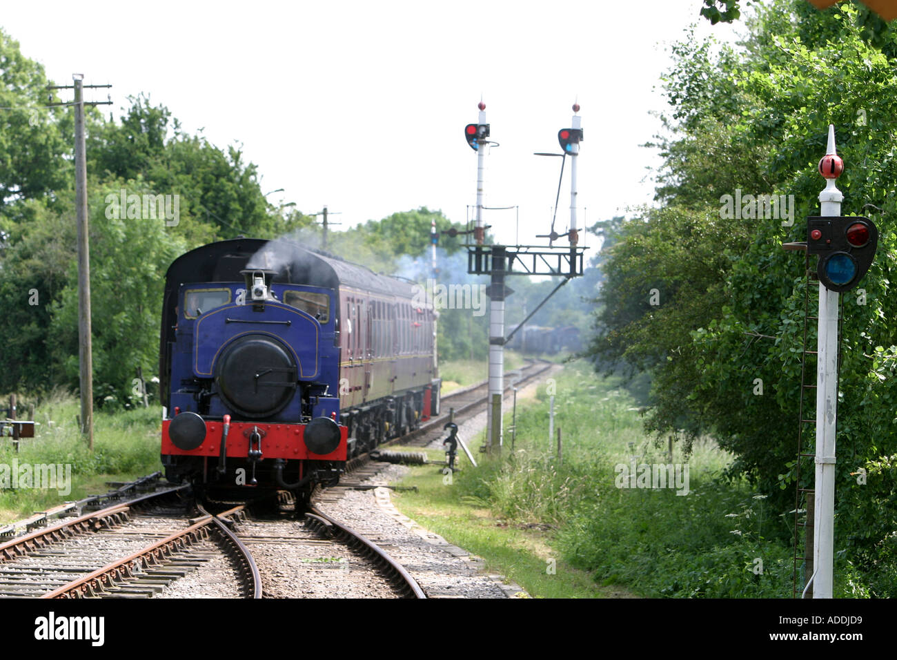 Train pulls into platform of preserved railway station Stock Photo - Alamy