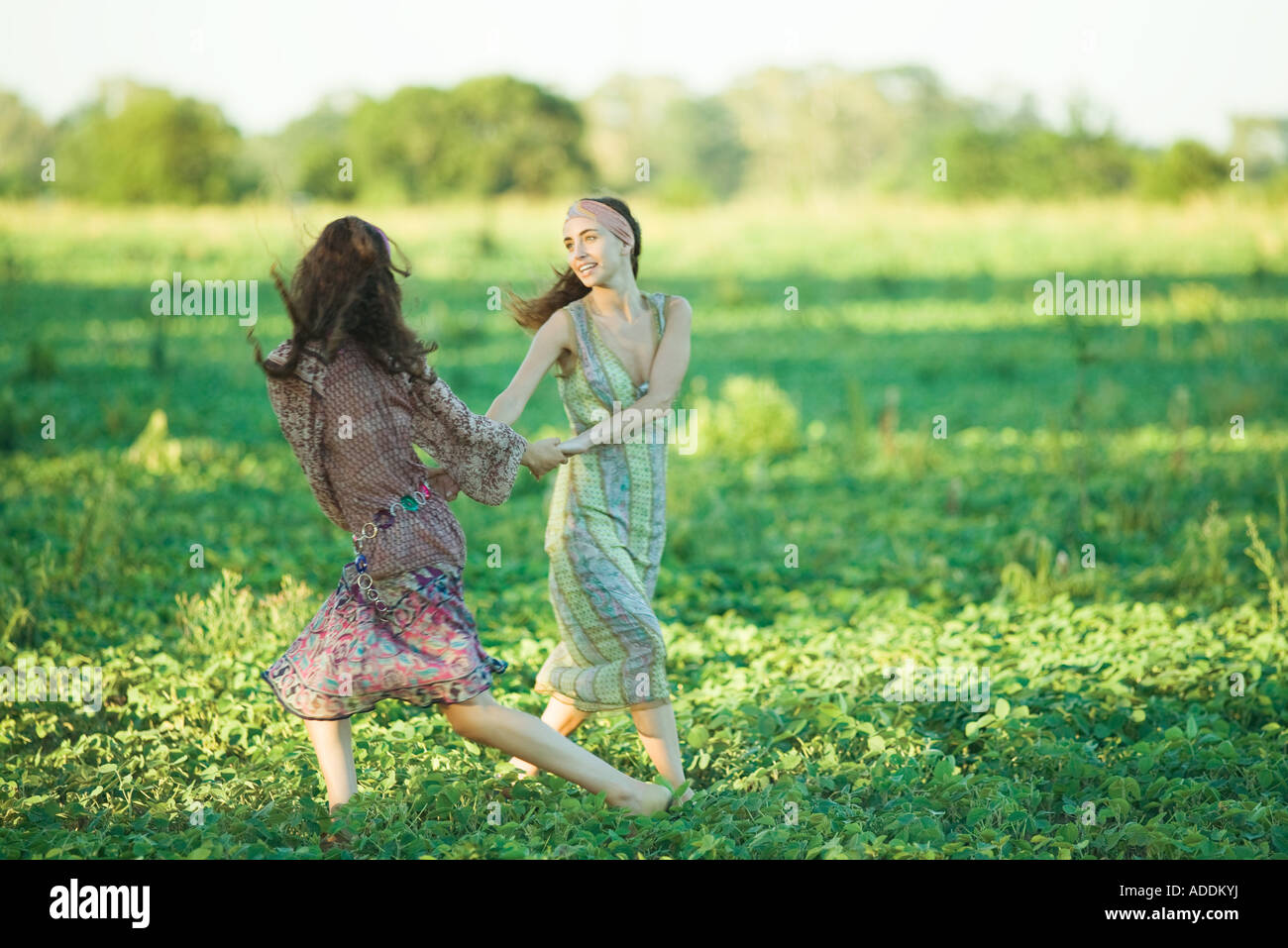 Young hippie women dancing in field Stock Photo - Alamy