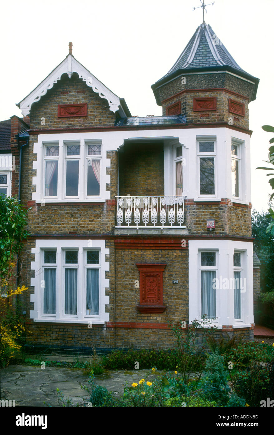 End of terrace Edwardian house with turret and wrought iron balcony ...