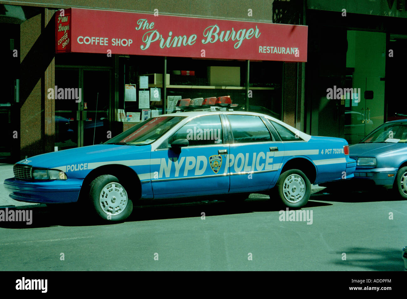 Parked NYPD police car parked outside a burger joint Stock Photo - Alamy