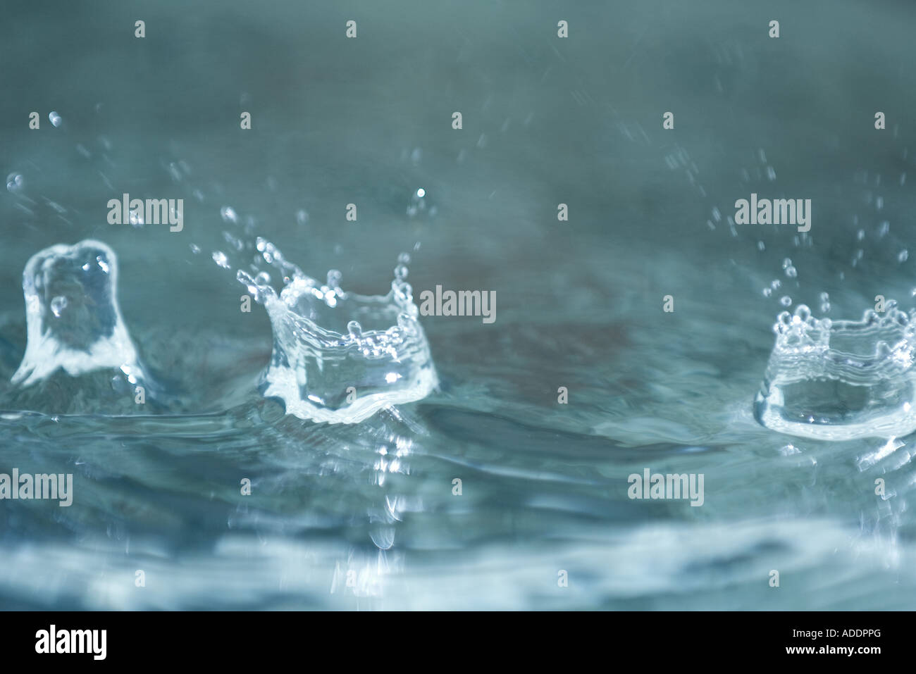 Drops of water hitting surface of water Stock Photo - Alamy