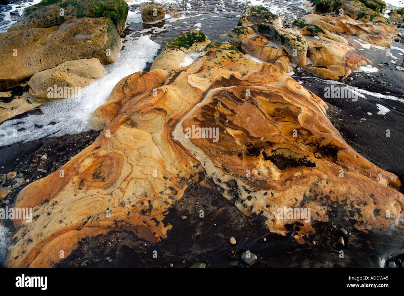Marbled Rock Formation on Whitby Beach Stock Photo - Alamy