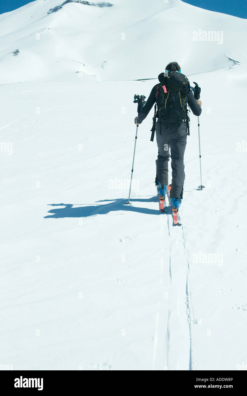 Skier heading toward mountain, rear view Stock Photo - Alamy