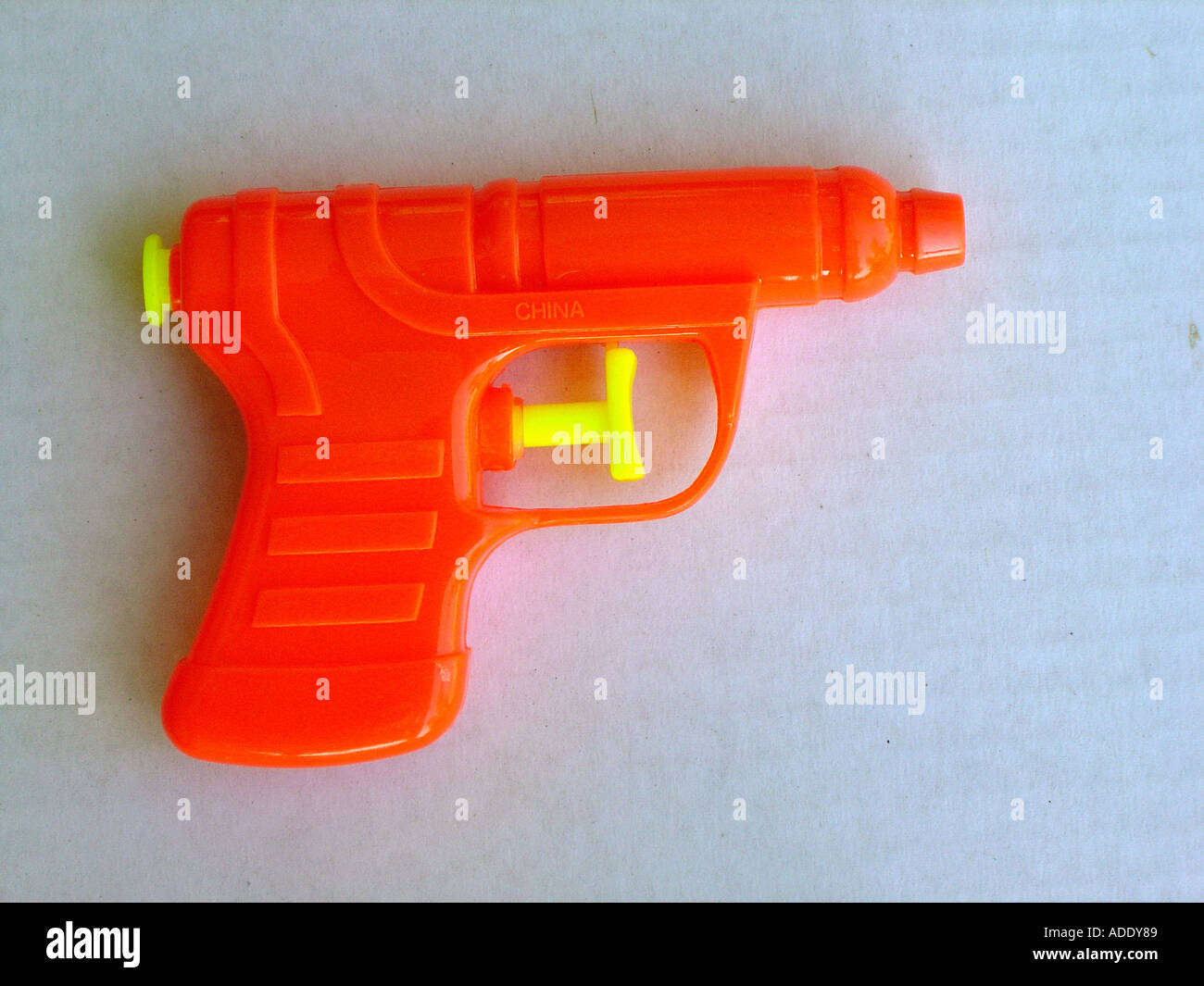 Still Life of a Orange Plastic Water Gun Squirt Gun Stock Photo - Alamy