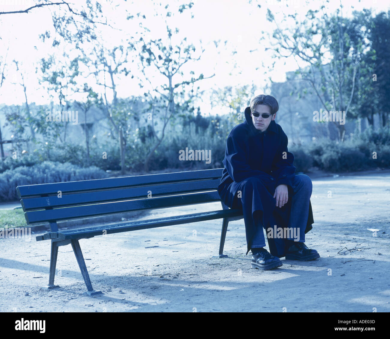 Man sitting on a bench in park Stock Photo - Alamy