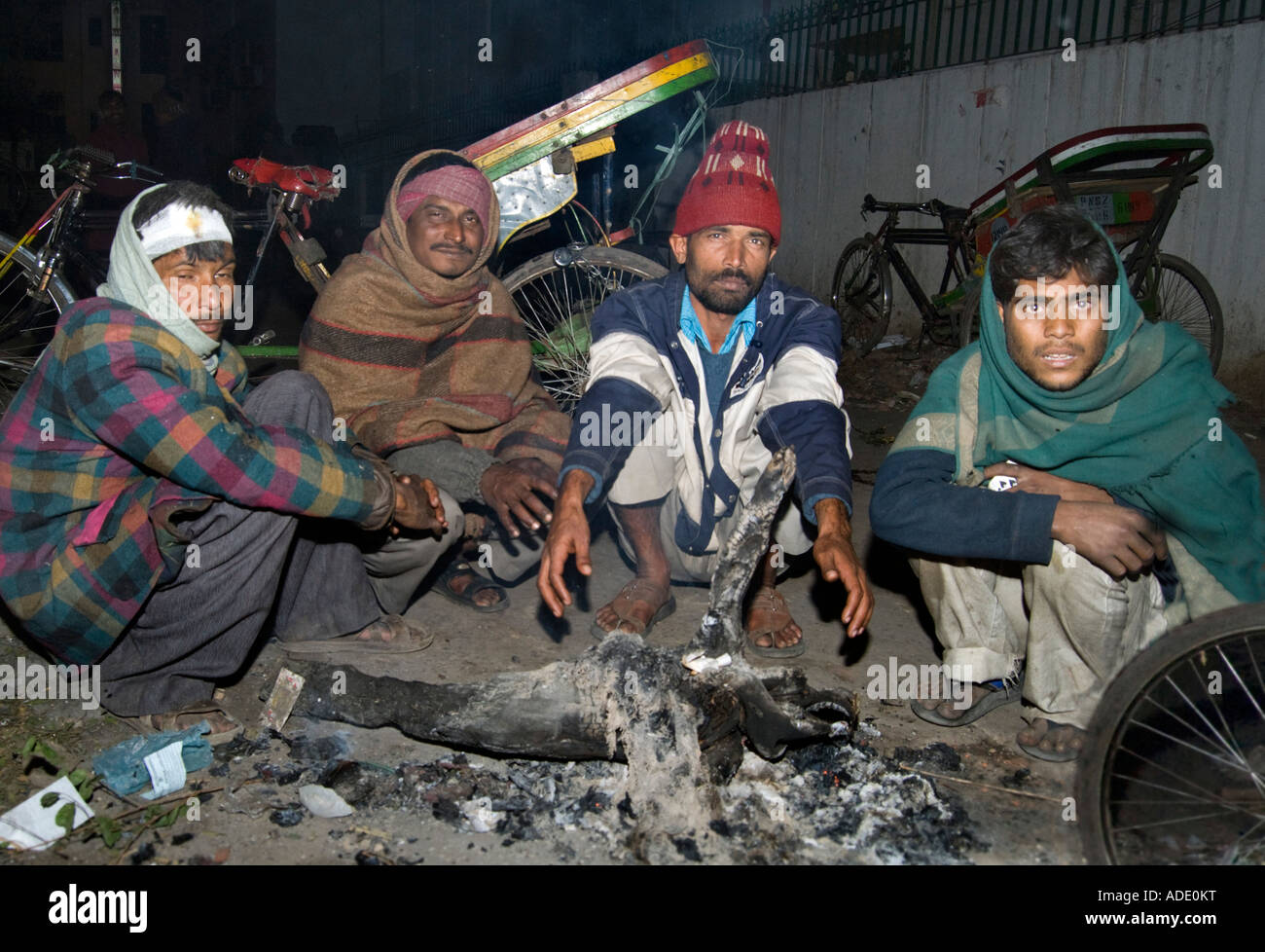 Rickshaw drivers by the fire in an Old Delhi backstreet on a cold ...