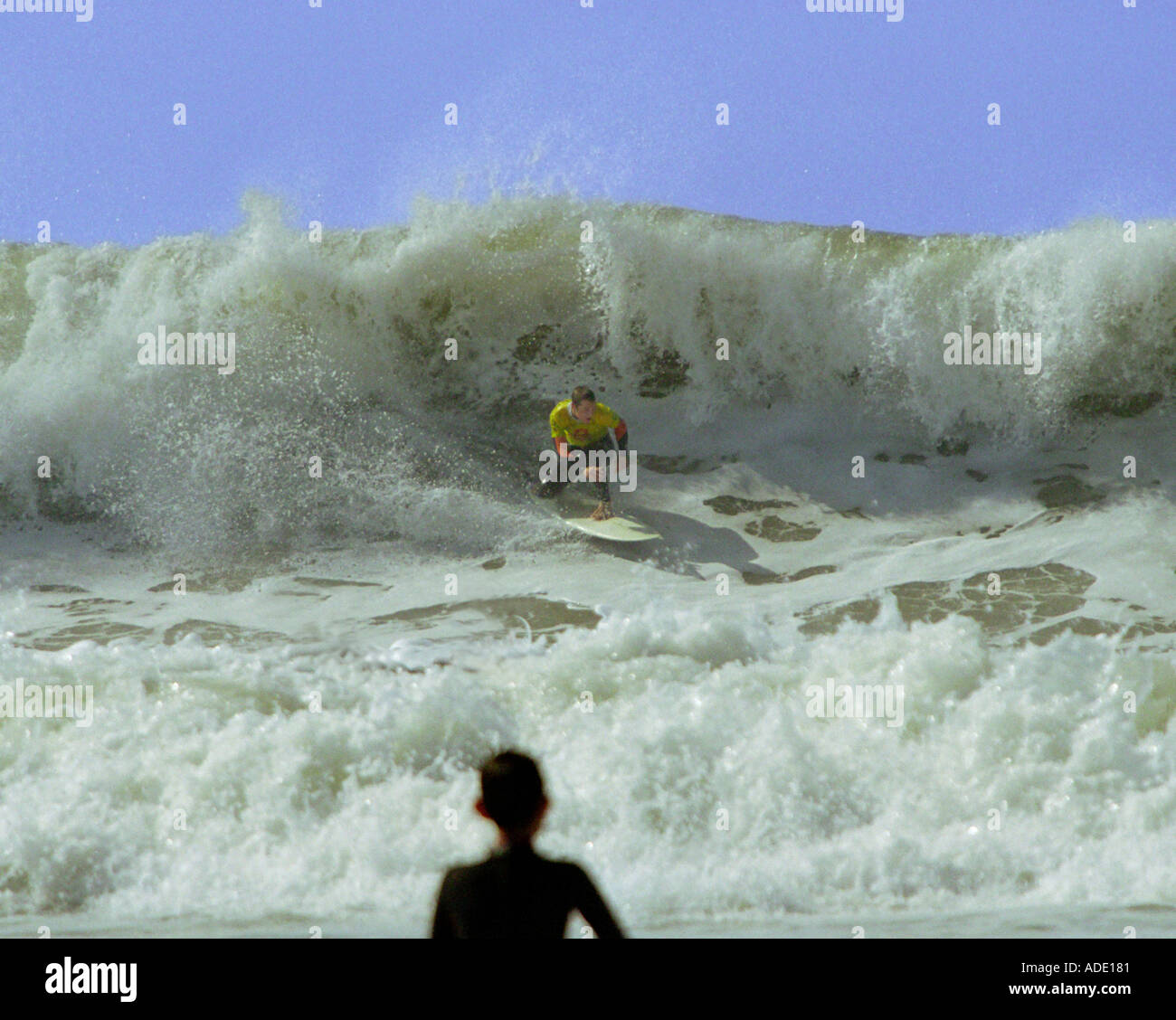 Surfer flies along the wall of a falling wave trying to beat the break ...