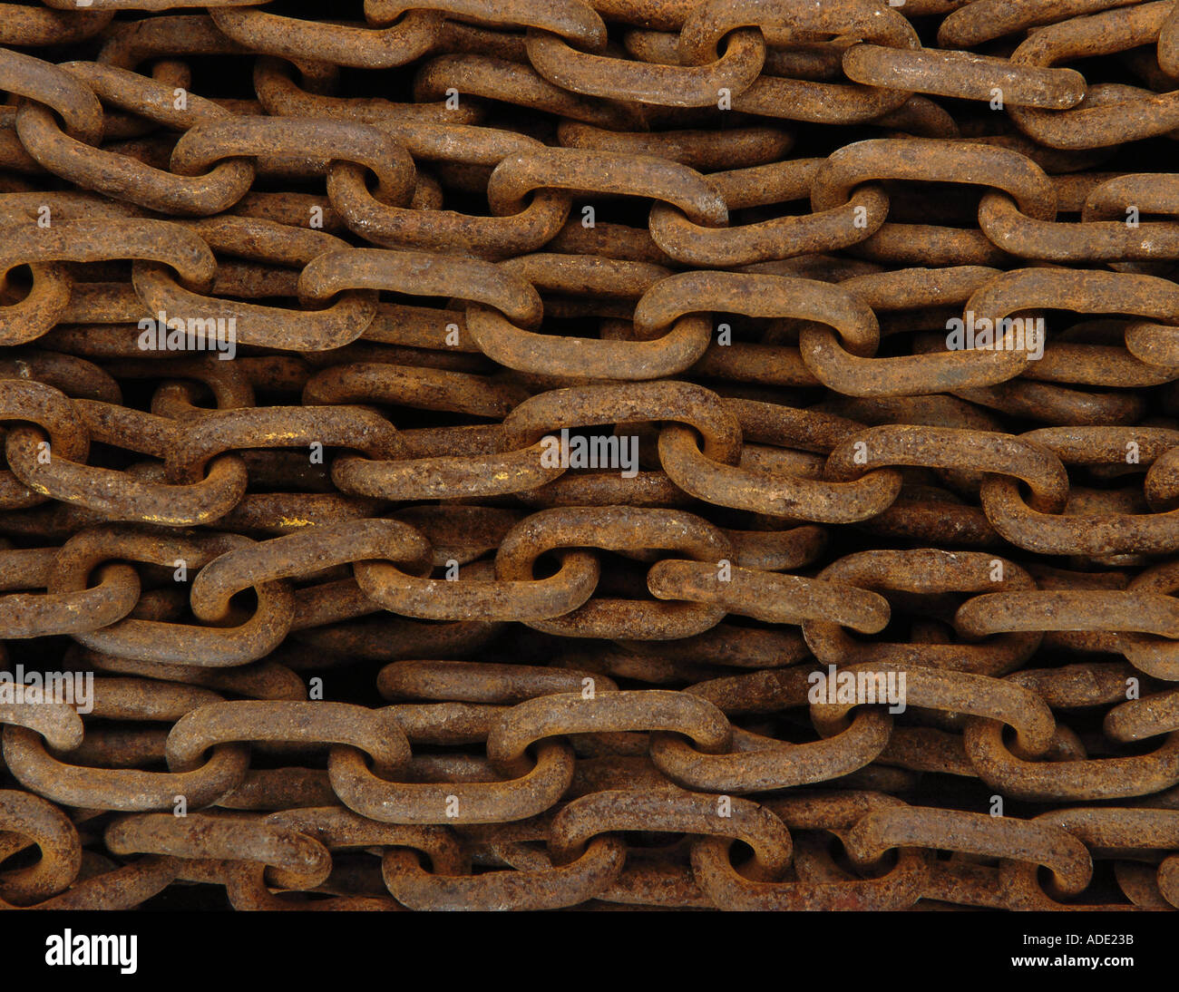 A close up of old brown rusty industrial chains forming horizontal rows ...
