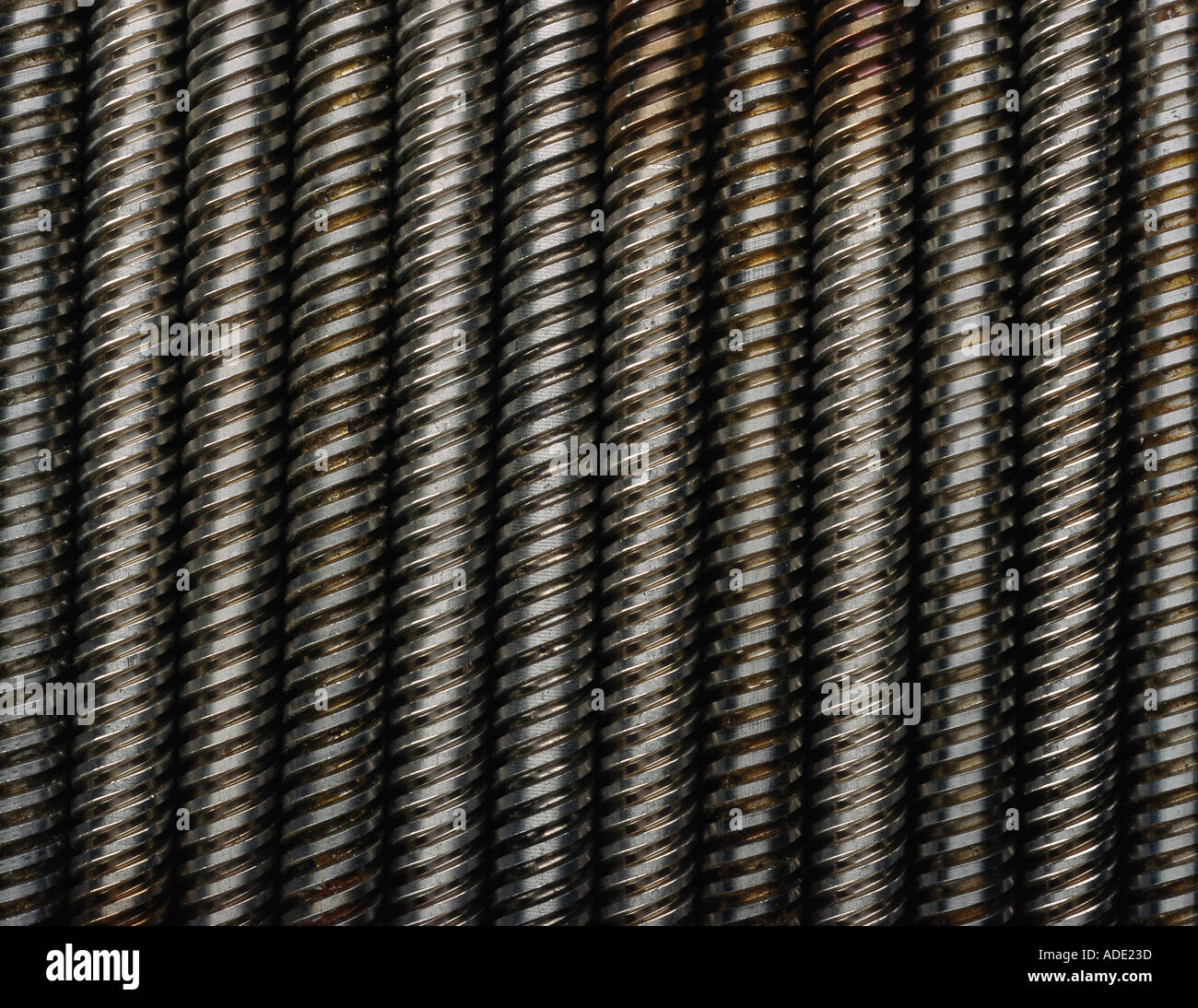 A close up or background of gray shiny industrial grooved metal pipes ...