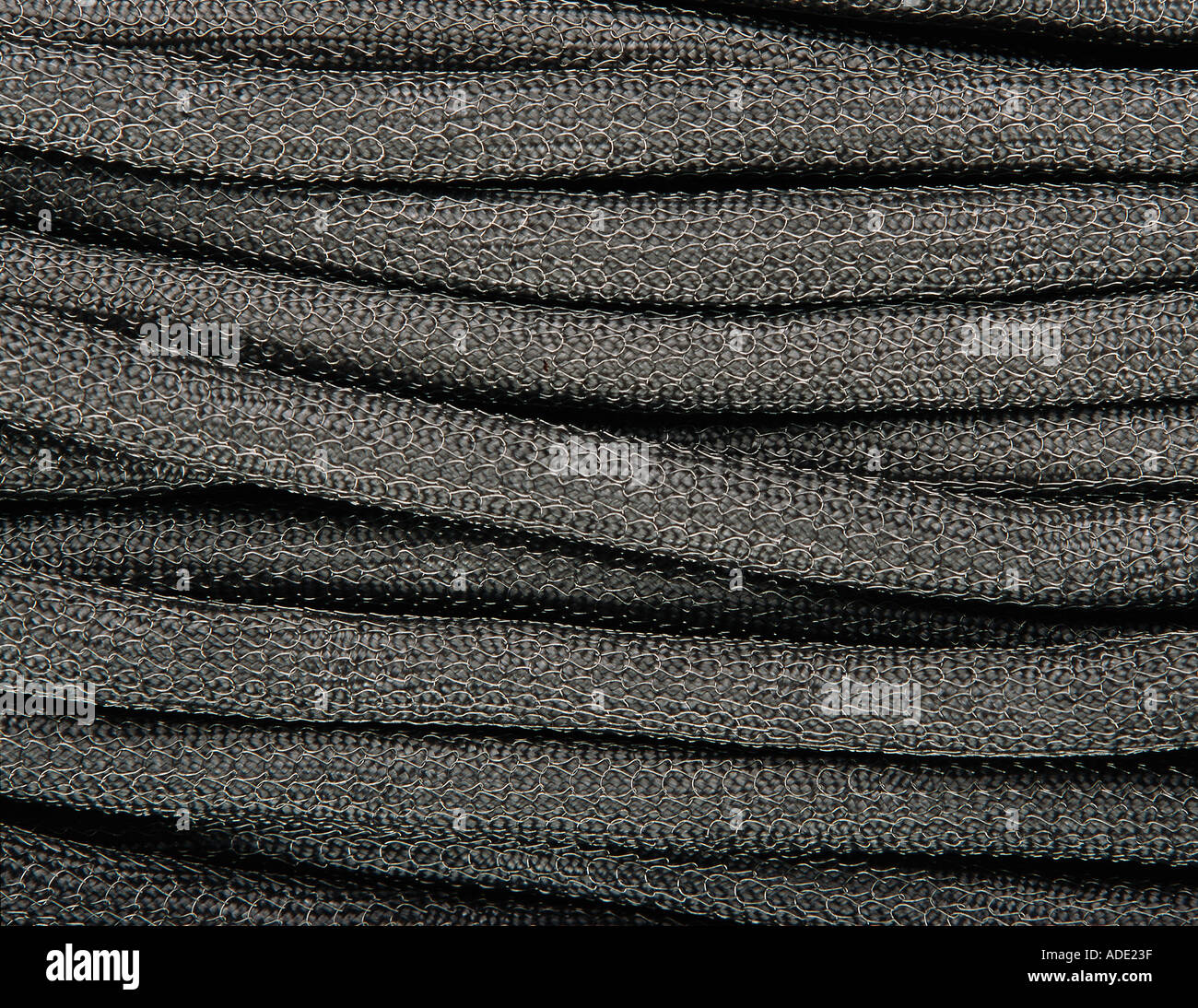 A close up or background of industrial flexible mesh metal tubes ...
