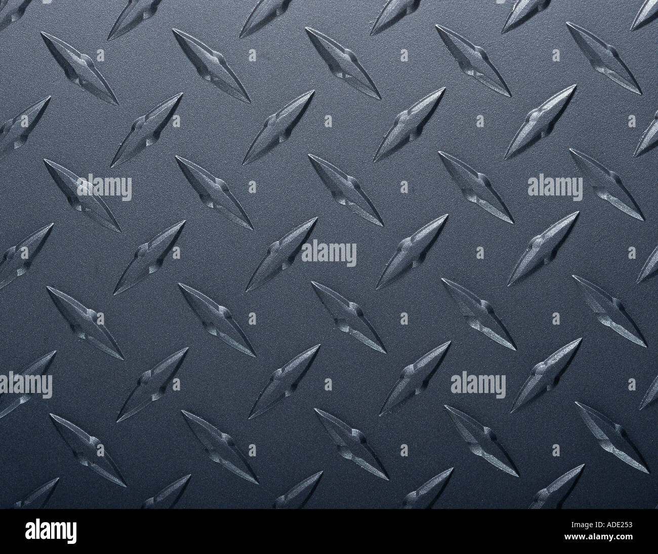 A close up of a piece of new gray colored industrial diamond plate or ...