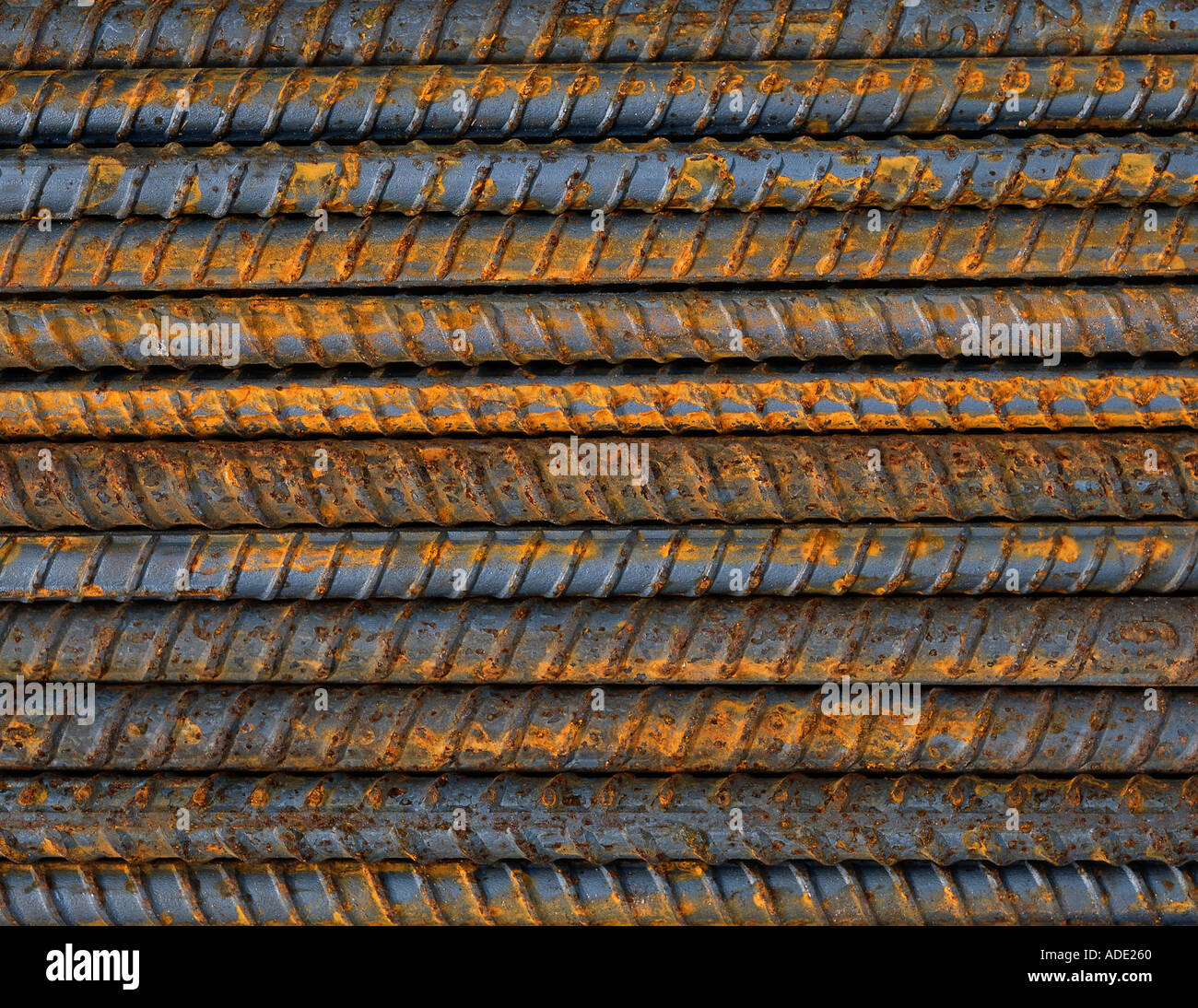 A close up of rows of old rusted orange and gray metal reinforcement ...