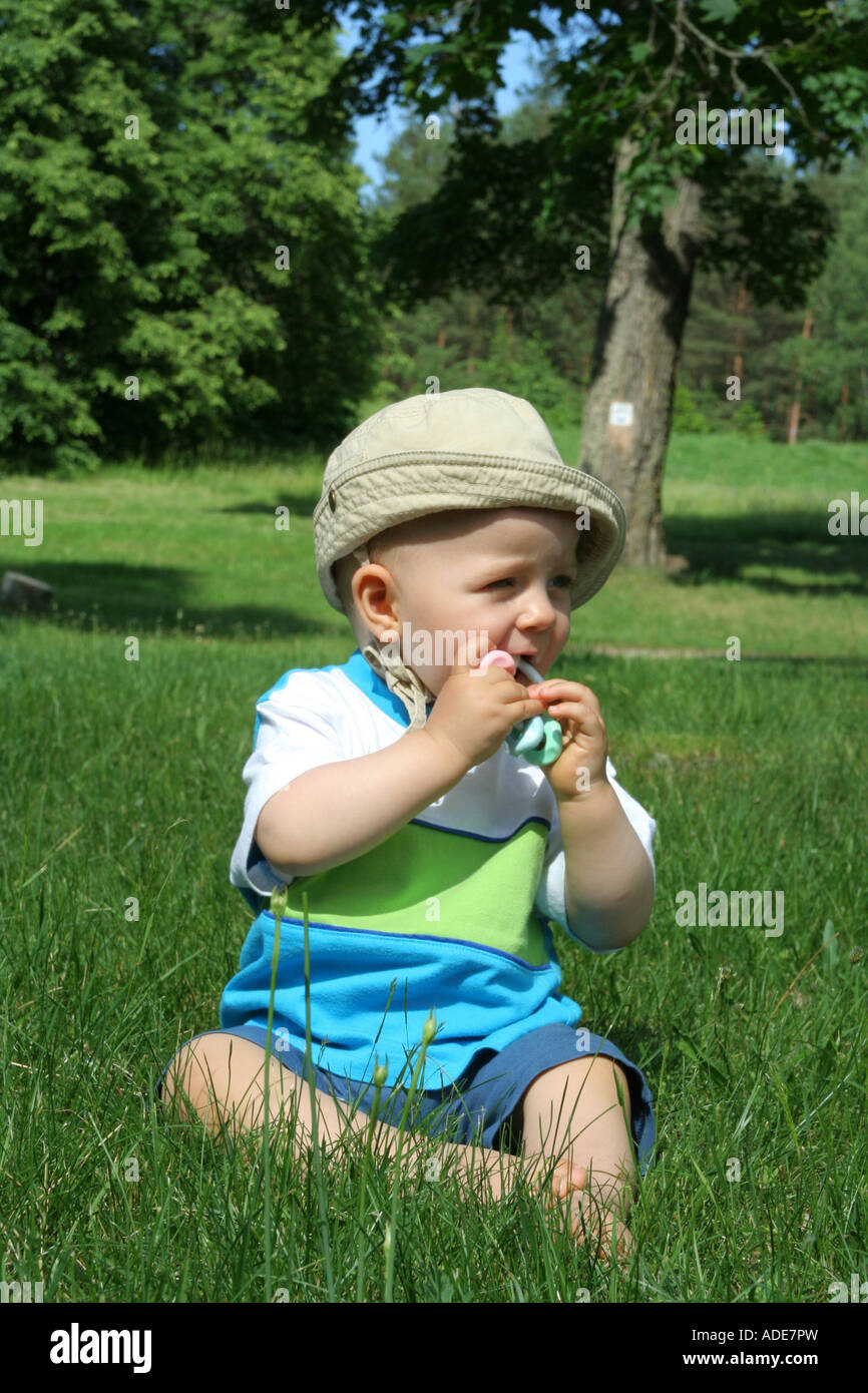 Boy sitting on the grass Stock Photo - Alamy