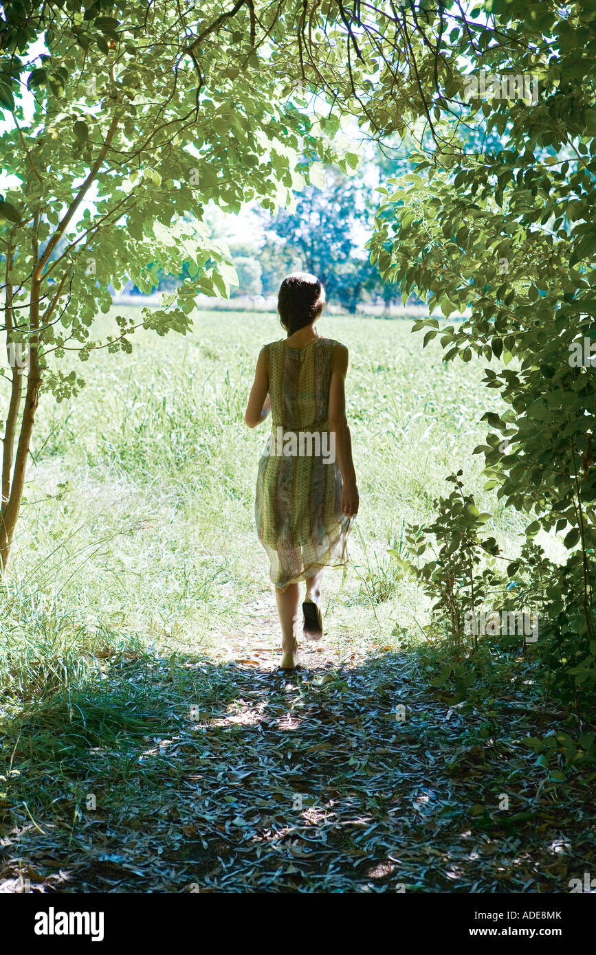 Young woman walking along rural path Stock Photo - Alamy