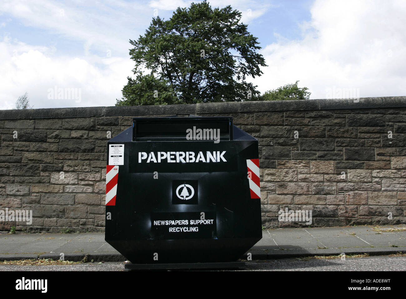 A PAPER RECYCLING BIN ON THE ROAD IN FRONT OF A TREE Stock Photo - Alamy