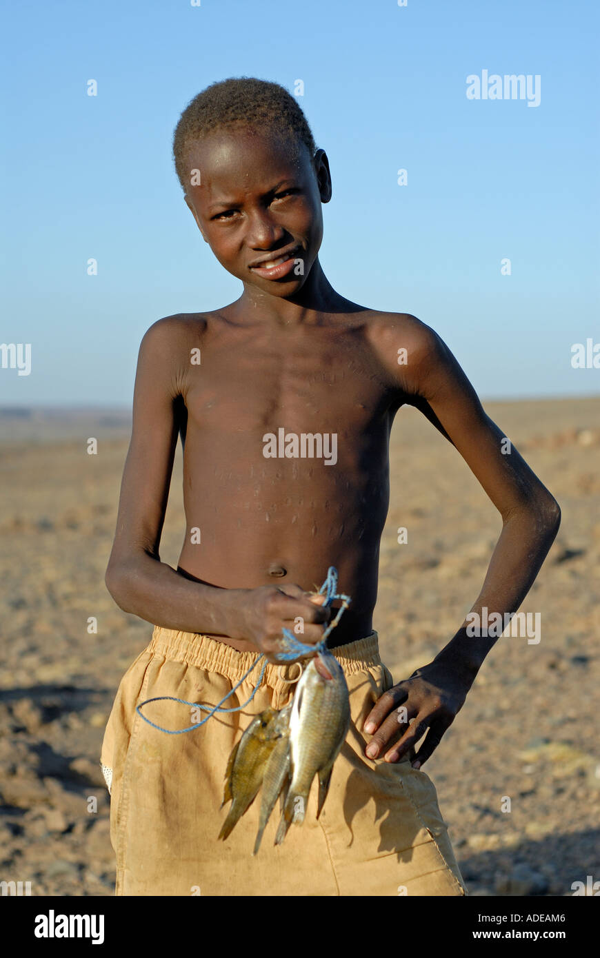 Boy and fish El Molo people at Lake Turkana Northern Kenya Stock Photo ...