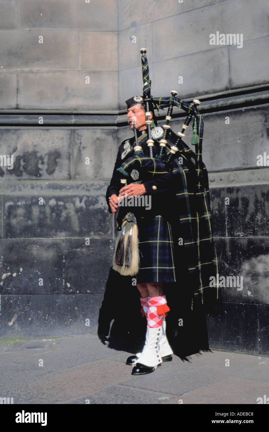 Scottish piper playing bagpipes on Parliament Square, The Royal Mile ...