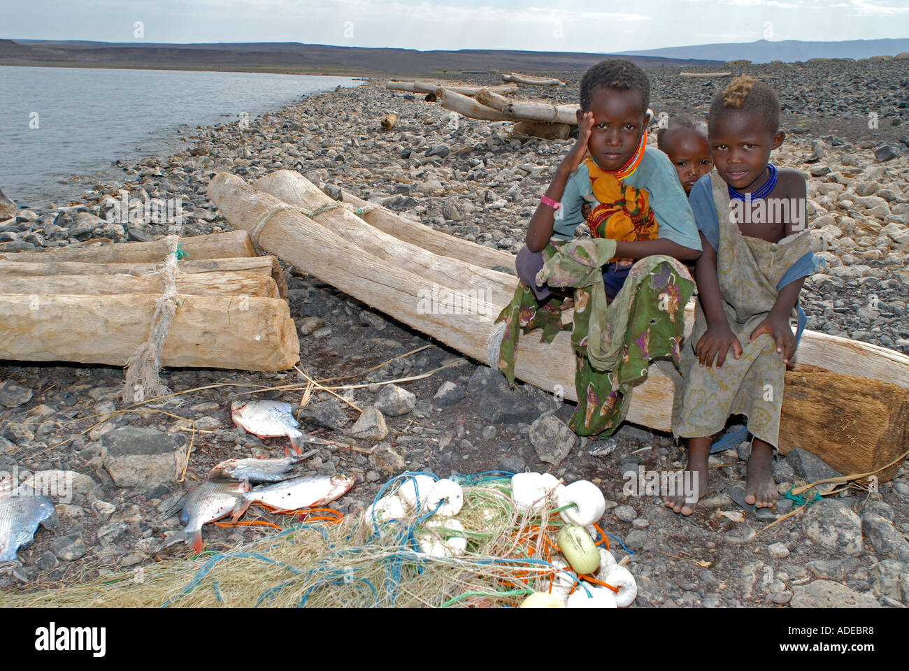 El Molo children resting on palm tree rafts after fishing Lake Turkana ...