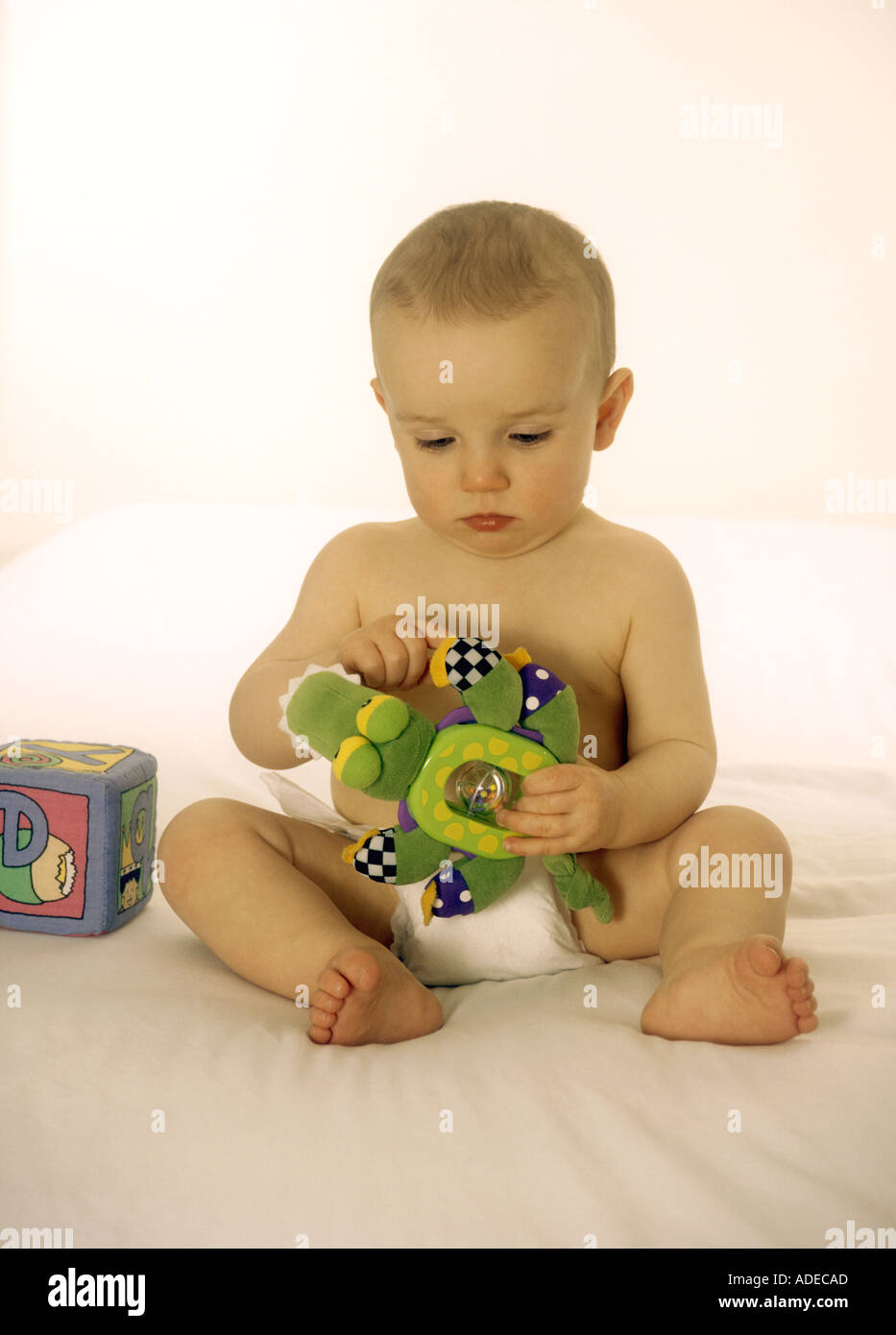 Baby boy holding rattle hi-res stock photography and images - Alamy