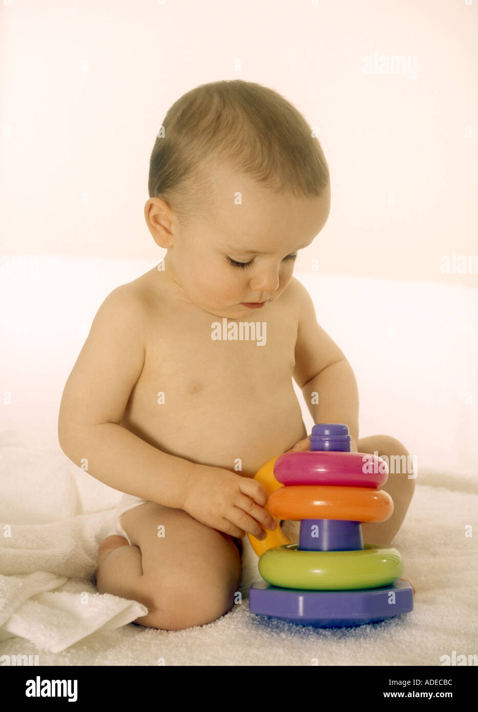 Baby boy playing with a plastic "stacking ring" toy Stock Photo - Alamy