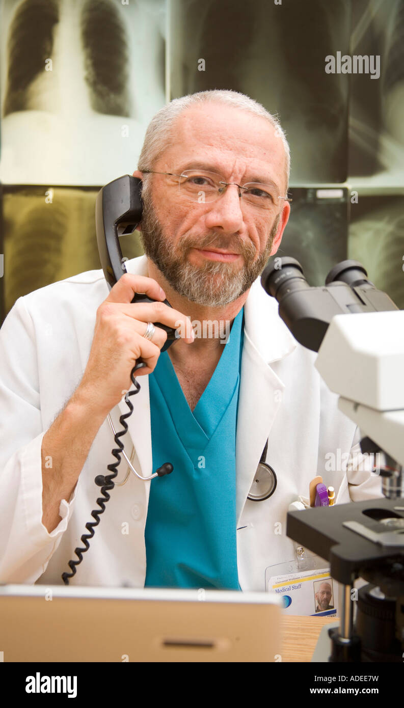 Doctor phones in diagnosis Stock Photo - Alamy