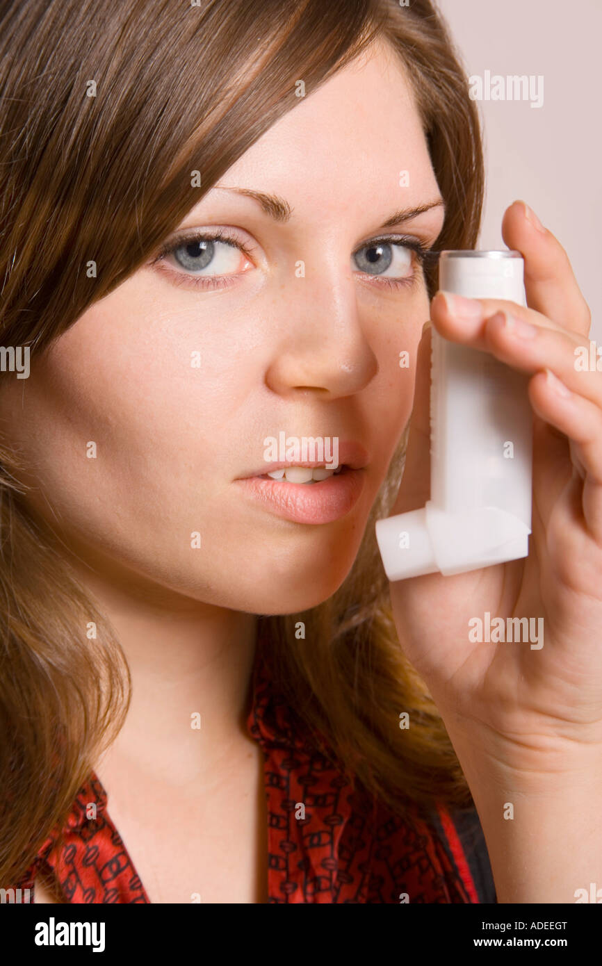 Young woman using an inhaler (or puffer Stock Photo - Alamy