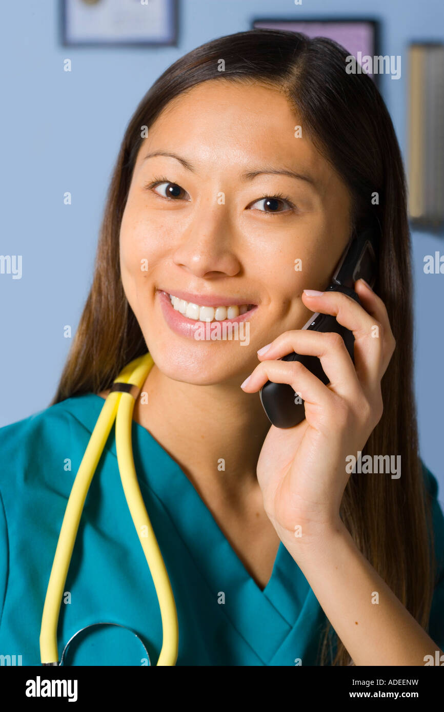 Nurse uses her cell phone Stock Photo - Alamy