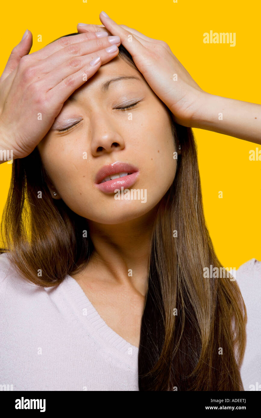Chinese American woman with headache pain. Perhaps she has lots of ...