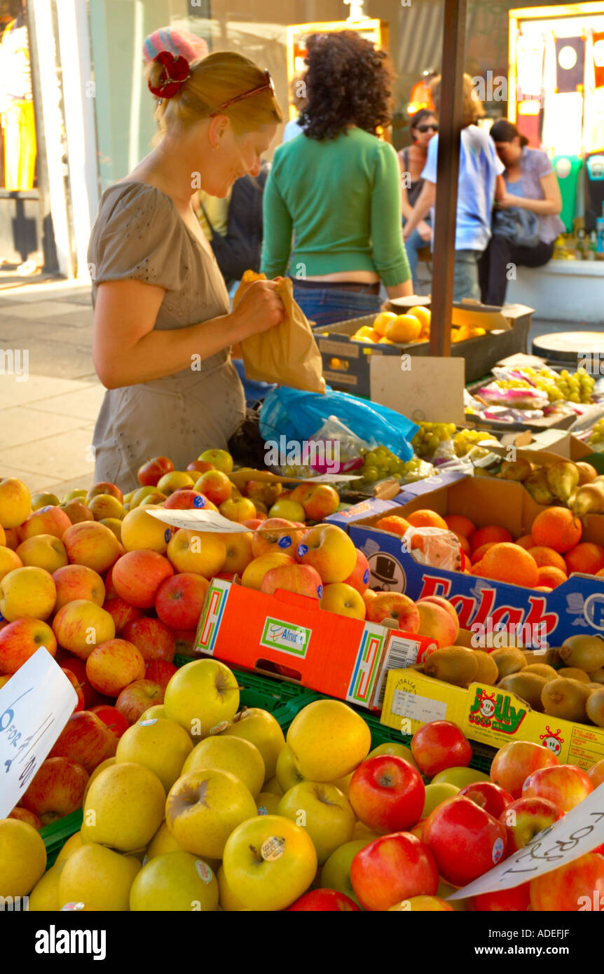Buying fresh produce at Portobello Road market in west London England ...