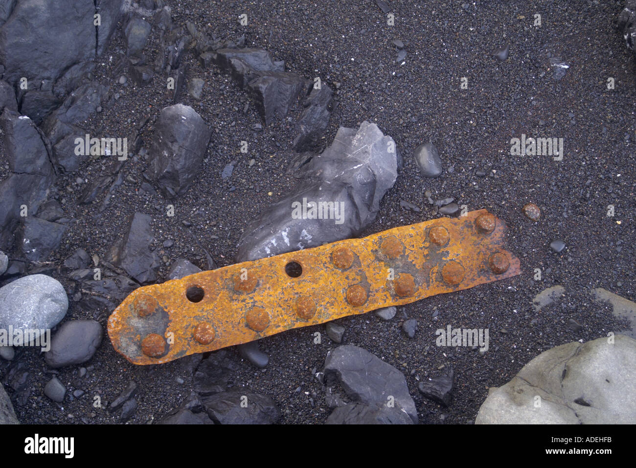 rusty steel ship hull reinforcing strip on black sand beach Stock Photo ...