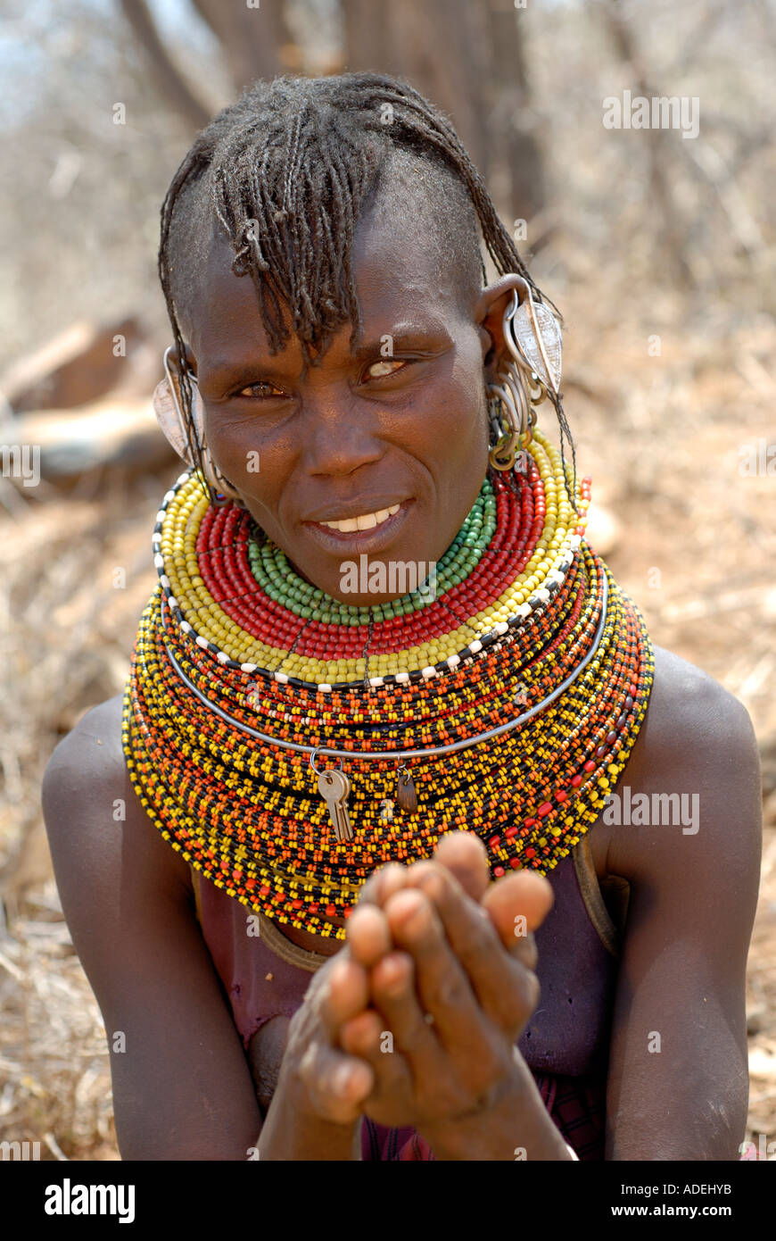 Blind Turkana woman wearing colorful bead necklaces and ear rings ...