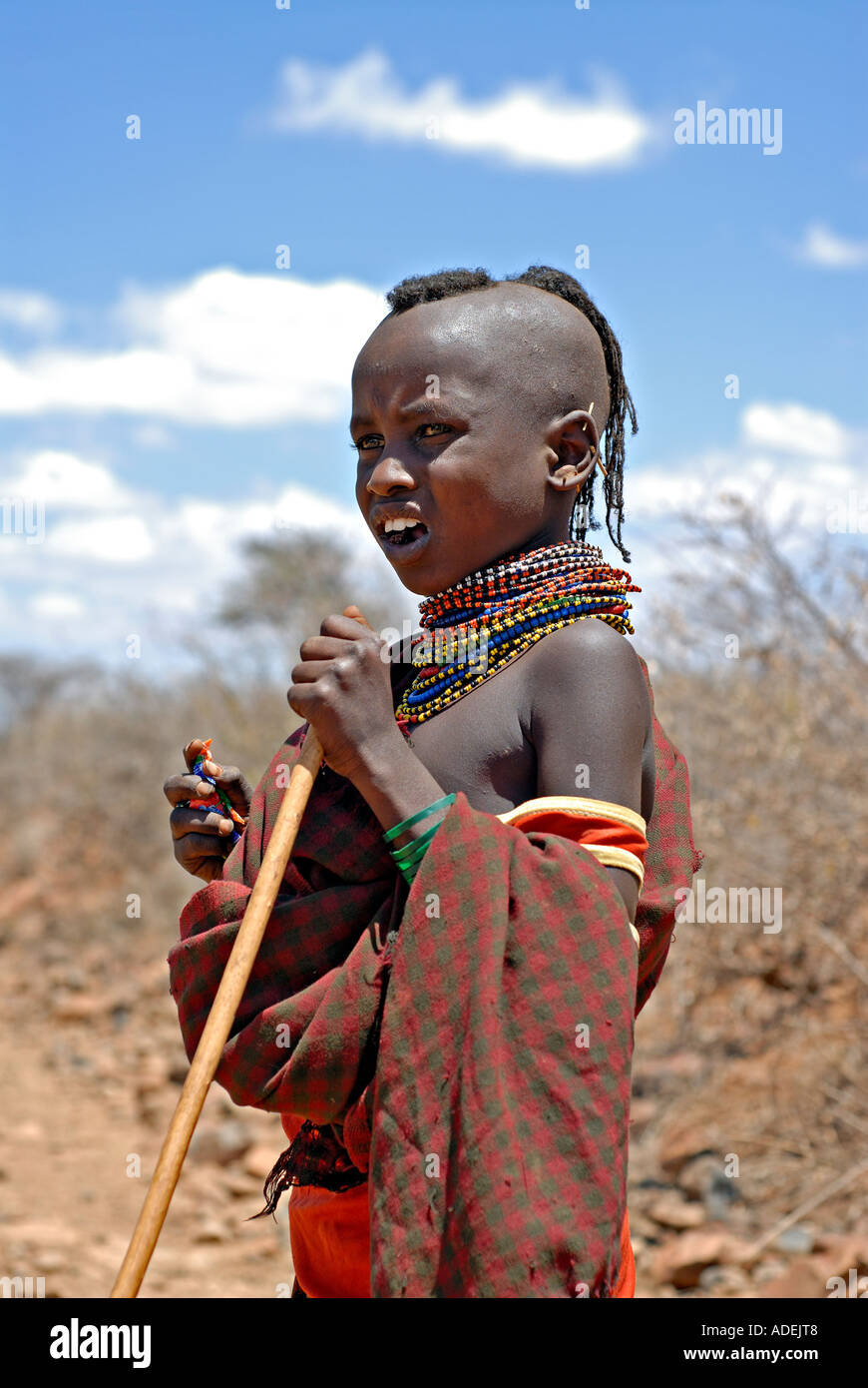 Little Turkana boy wearing typical tribal hairdressing and bead ...