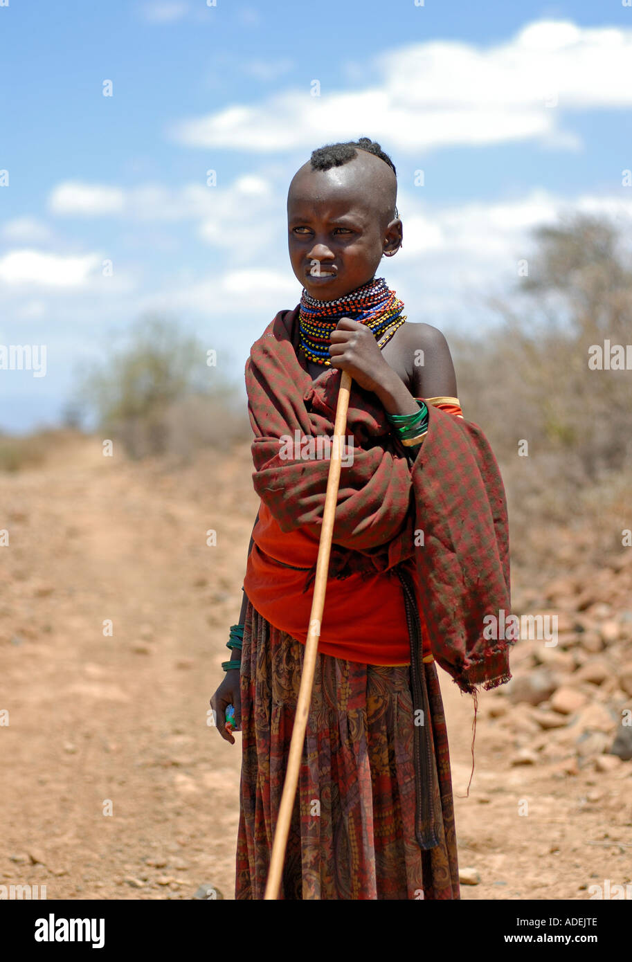 Little Turkana boy wearing typical tribal hairstyle and bead ornaments ...