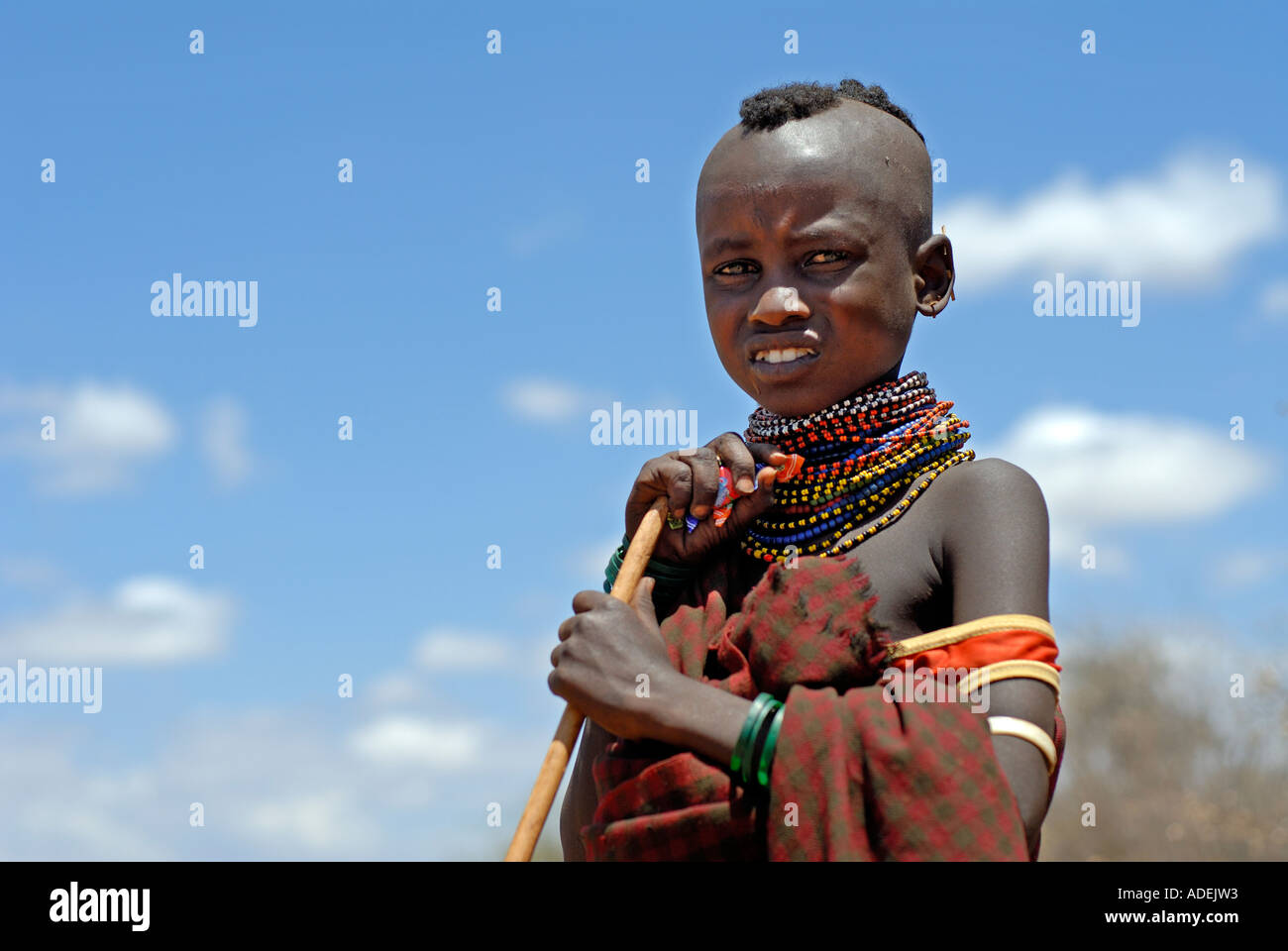 Little Turkana boy wearing typical tribal hairstyle and bead ornaments ...